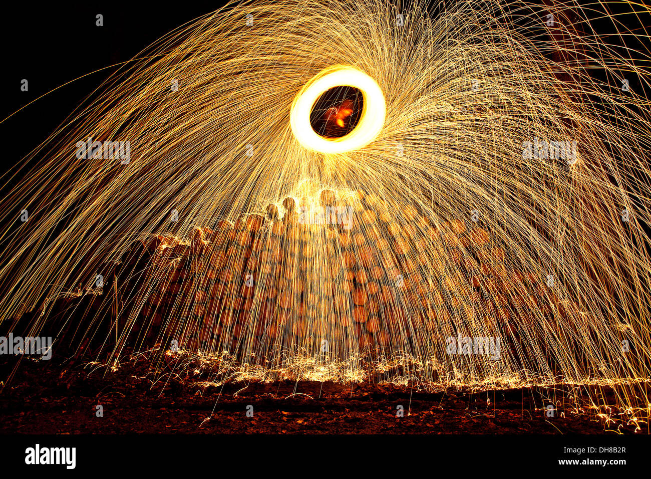 Sparks flying from wire wool on fire Stock Photo - Alamy