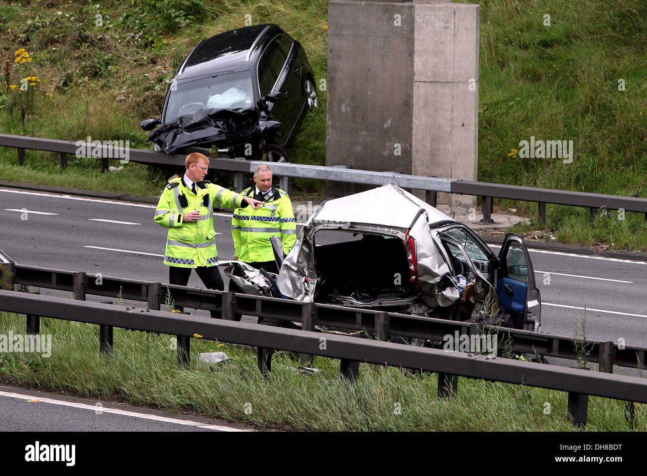 Police officers inspect the scene of a crash on the M62 near Manchester ...