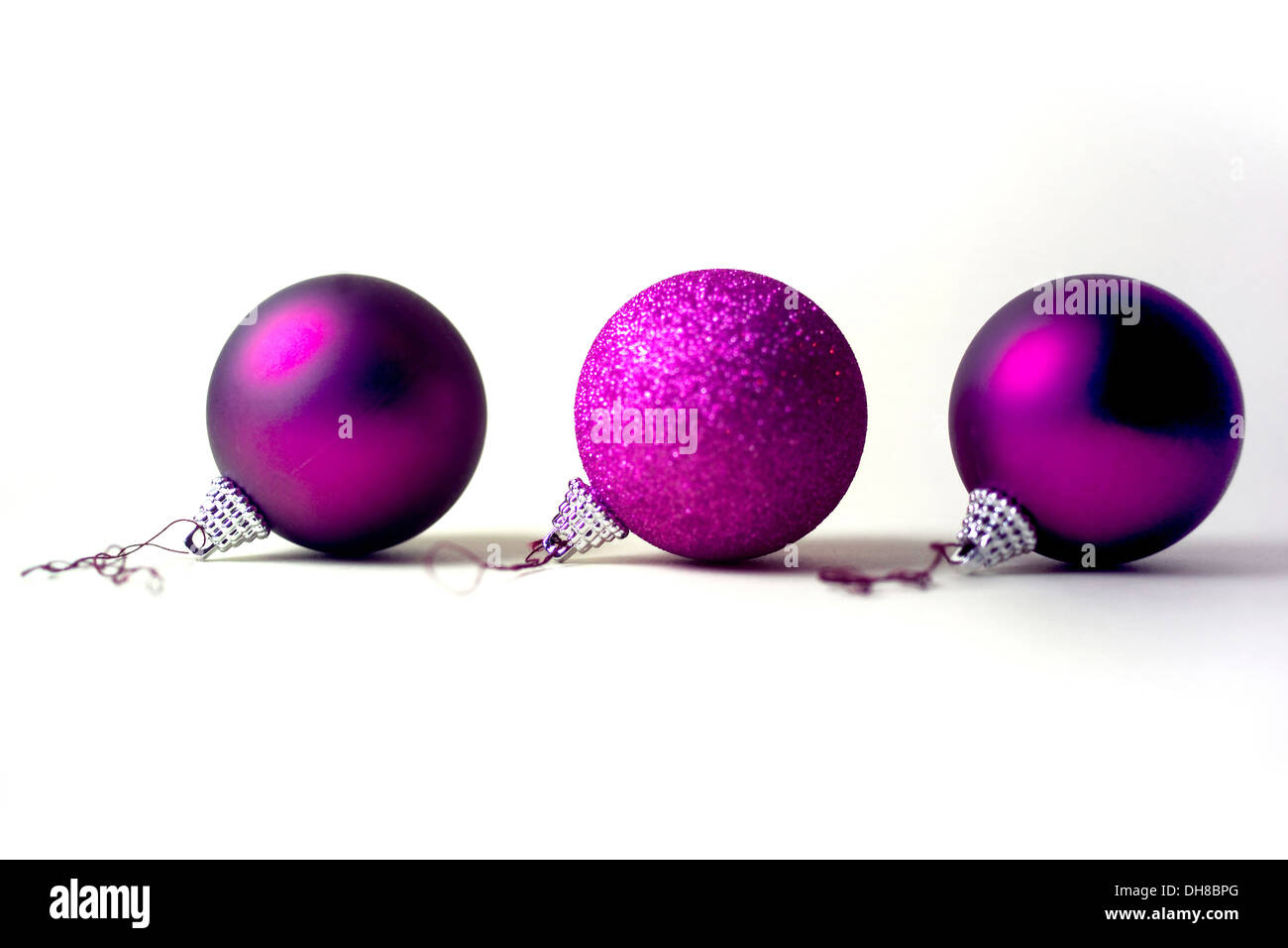 Three Purple christmas baubles Stock Photo - Alamy