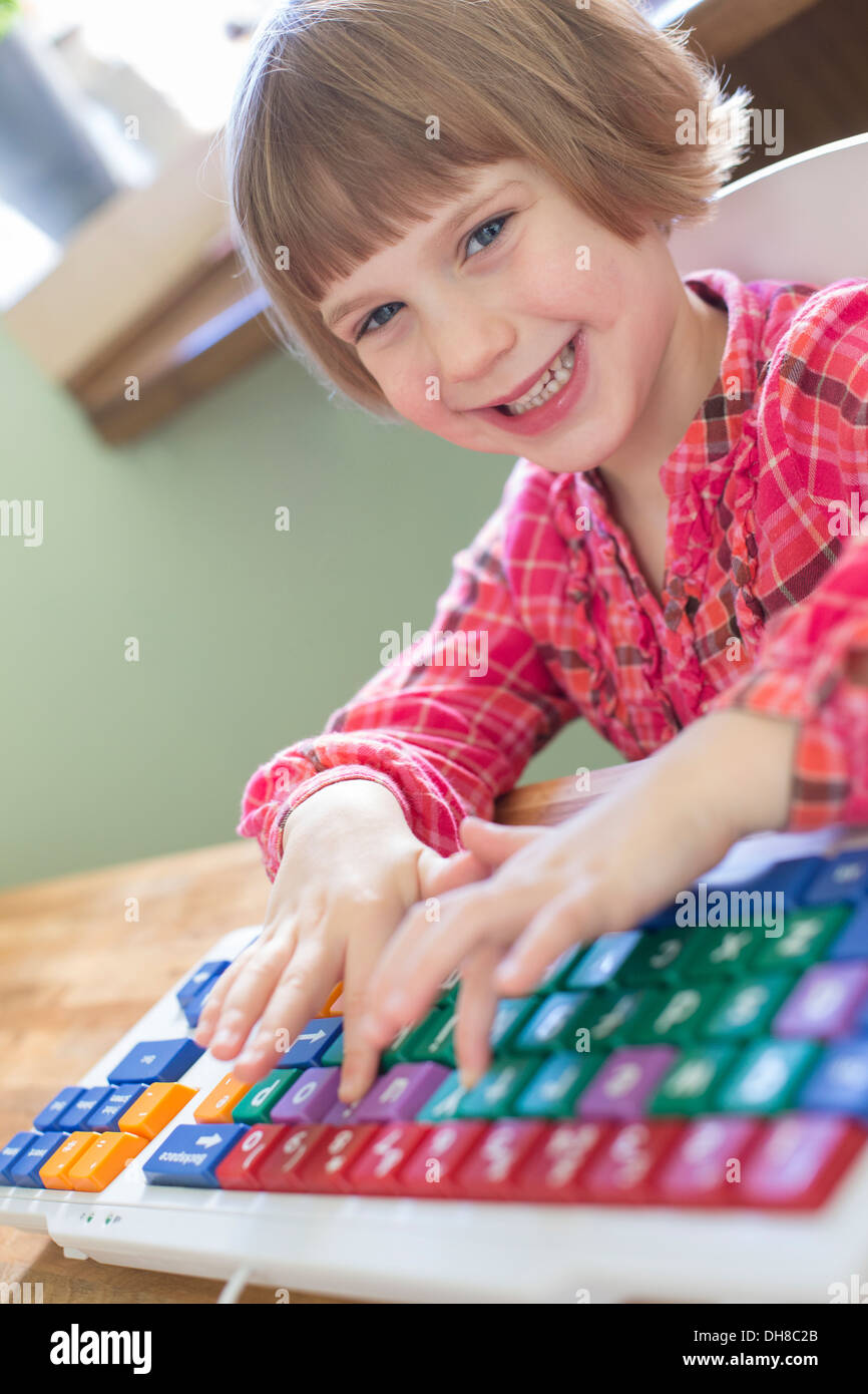 Young Girl Using Computer Keyboard At Home Stock Photo - Alamy