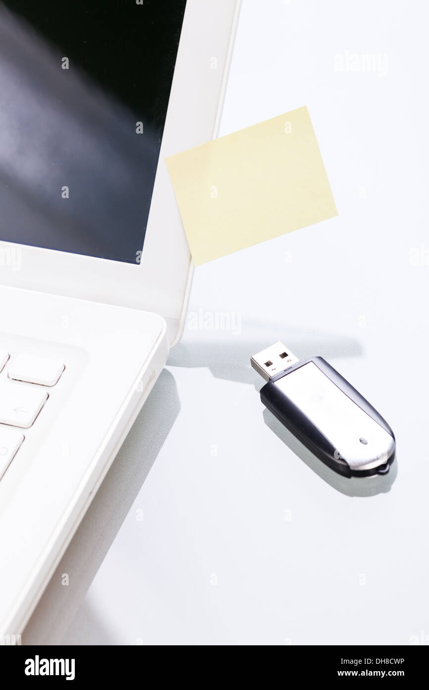 notebook laptop with post it memo and usb stick closeup macro objects ...