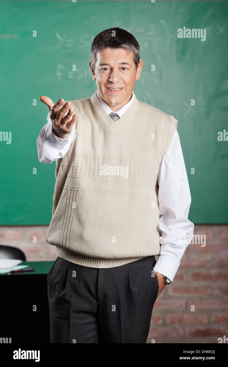 Confident Professor Gesturing In Classroom Stock Photo - Alamy