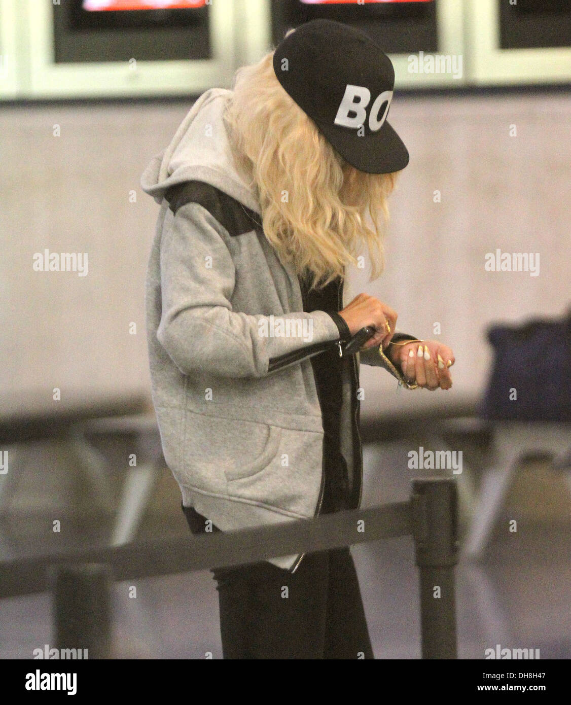 Rihanna arrives at LAX wearing a 'BOY London' cap singer was boarding a ...