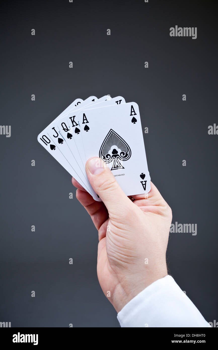 Playing cards being held in mans hand Stock Photo - Alamy