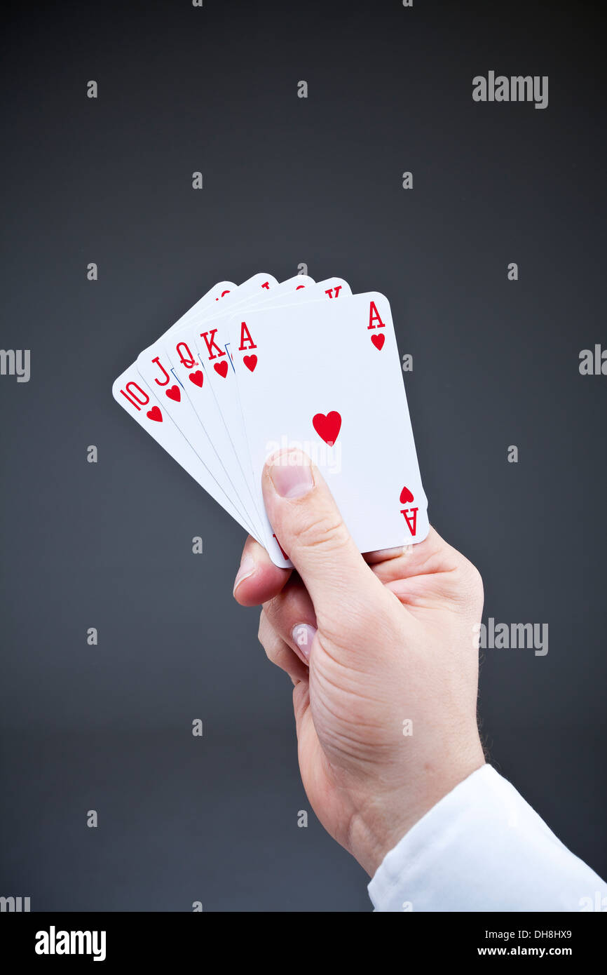 Playing cards being held in mans hand Stock Photo - Alamy