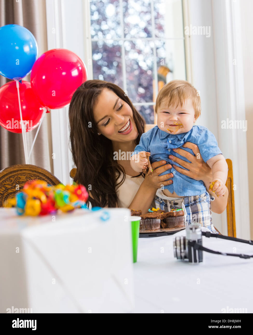 Mother Holding Boy With Messy Hands Covered With Cake Icing Stock Photo ...