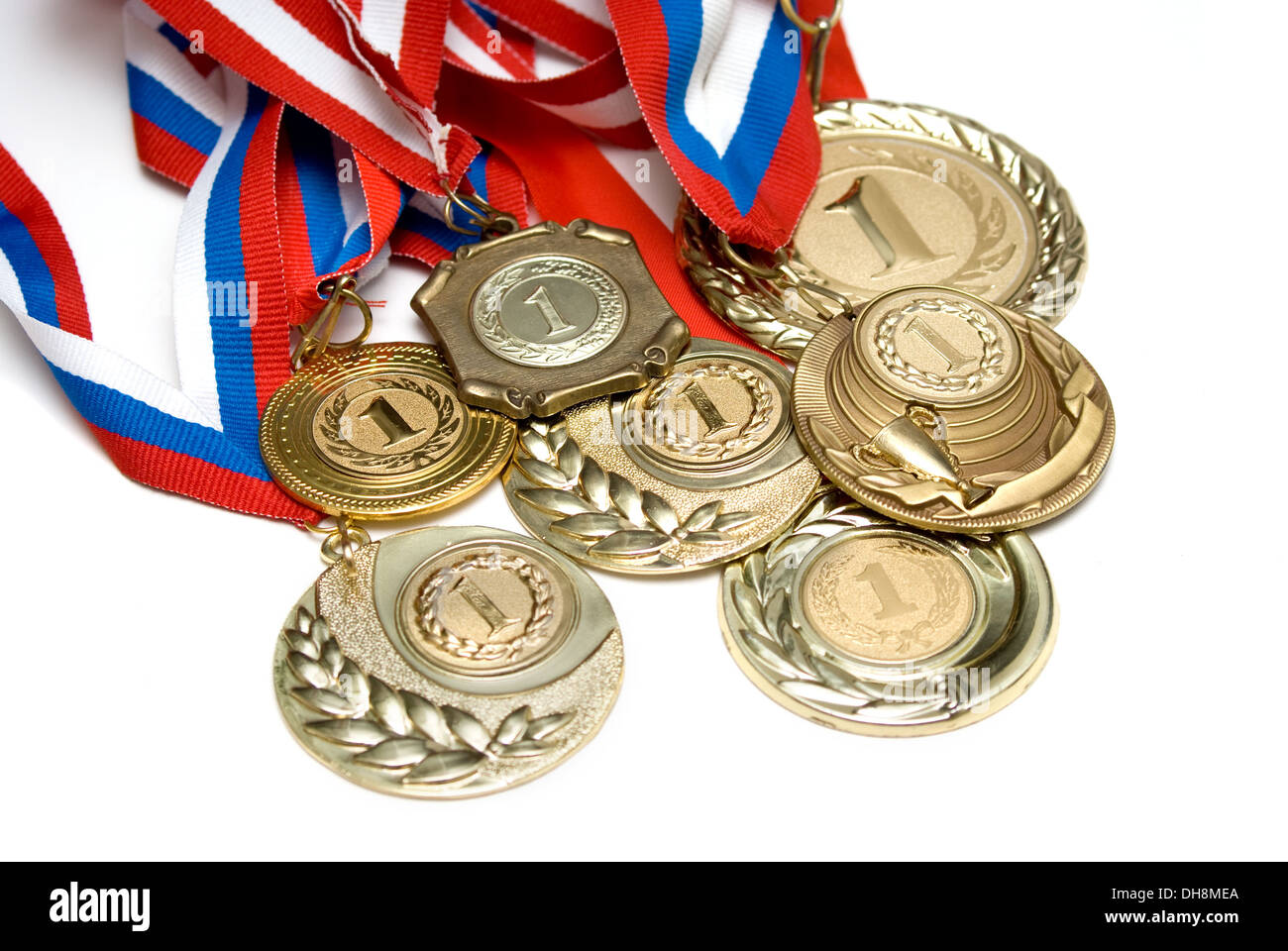 Several golden medals isolated on white Stock Photo - Alamy