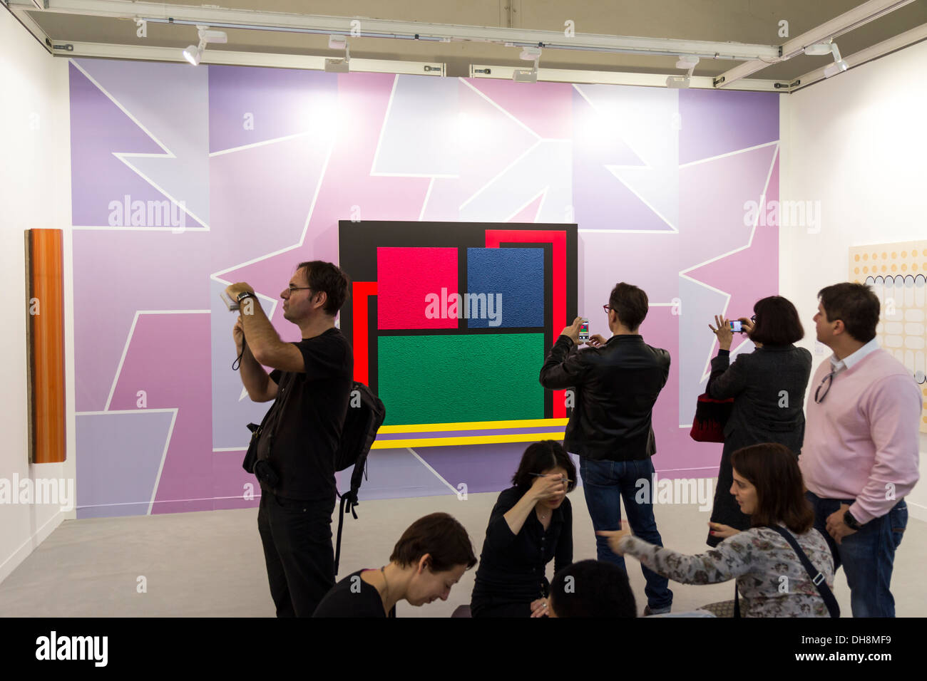 Art amateurs taking picture on a gallery stand at the Fiac 2013 ...