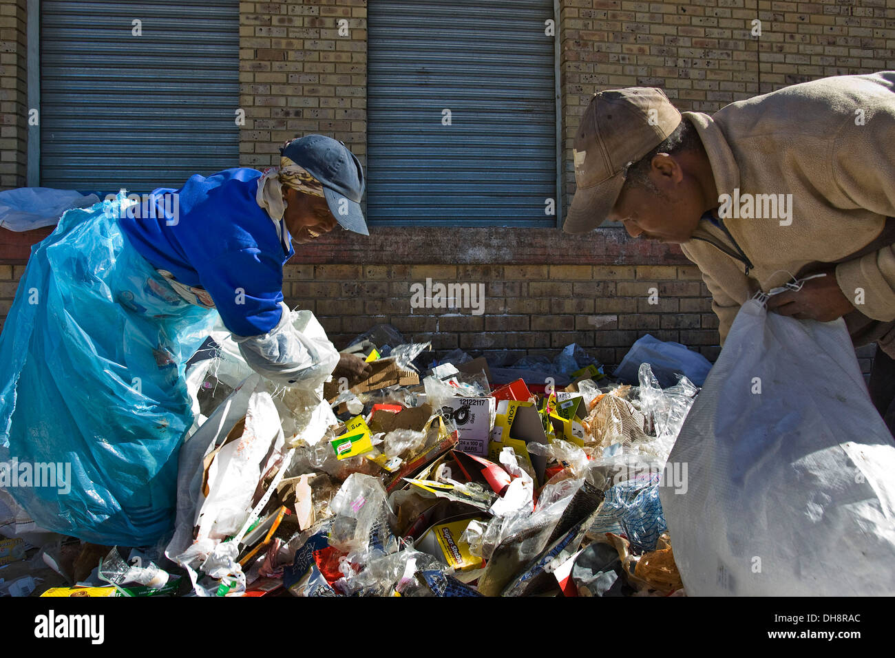 Workers sort through waste outside local grocery stores before ...