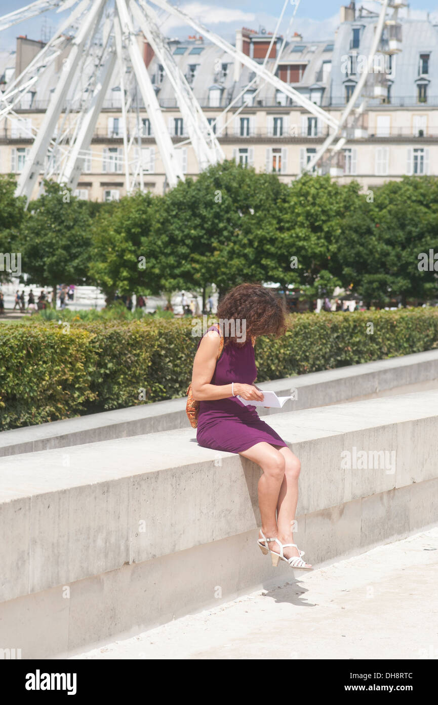 Paris, France - Young woman reading book outdoors Stock Photo - Alamy
