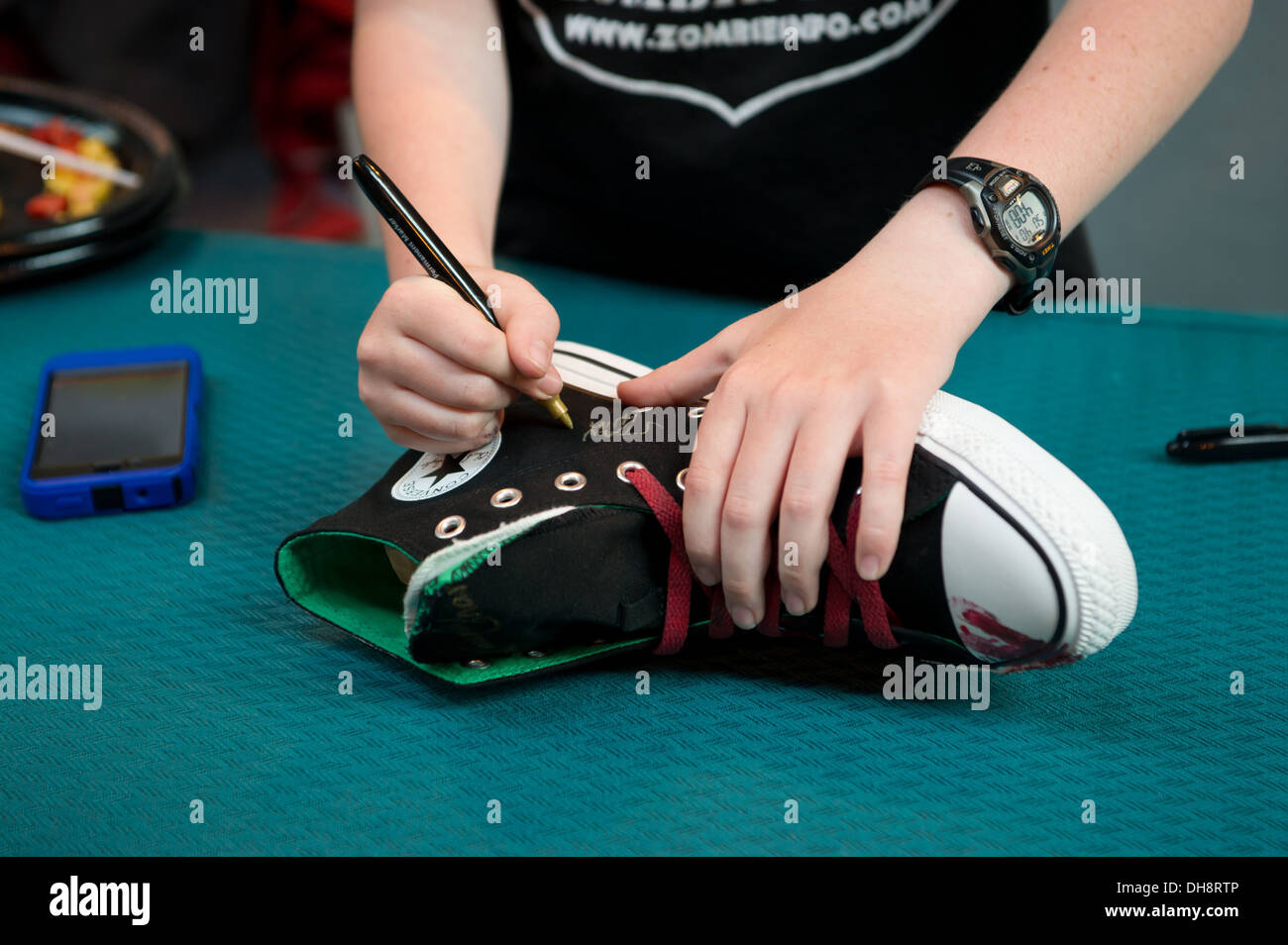 Chandler Riggs signs a hand painted shoe 2012 Memorabilia Show at NEC ...