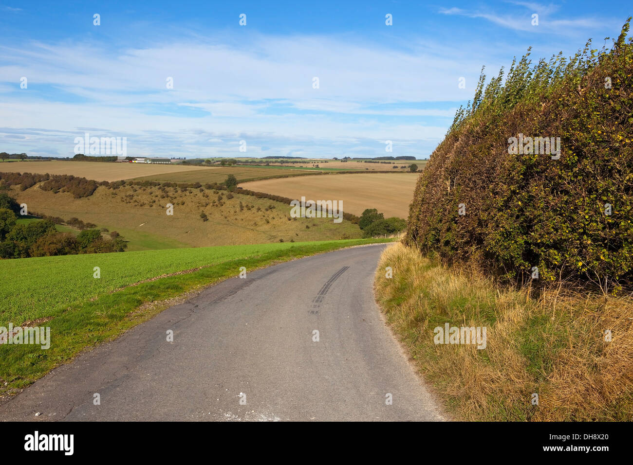 A steeply descending road through the patchwork landscape of the ...