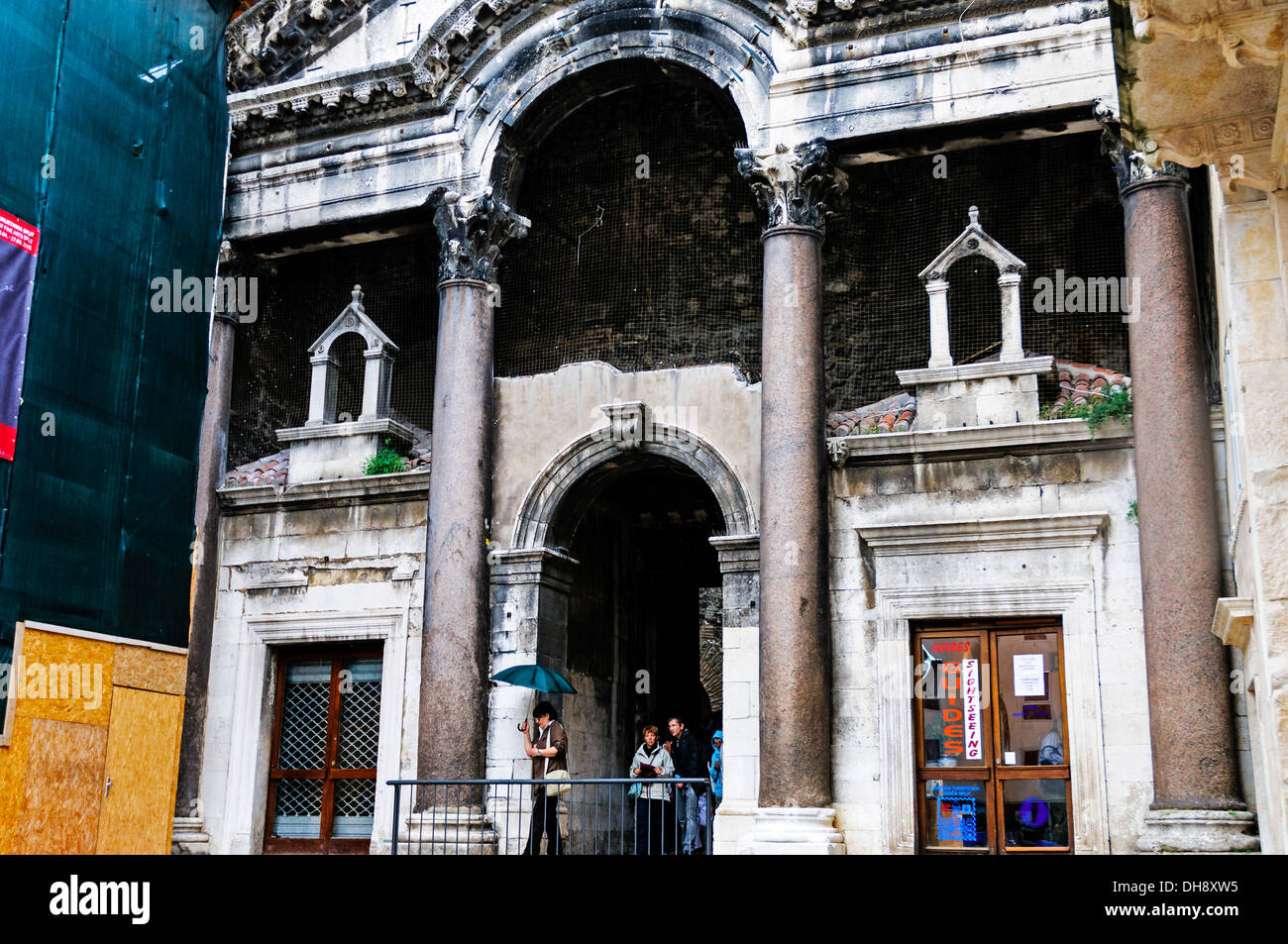 Tourists emerge from the arch in the monumental prothyron connecting ...