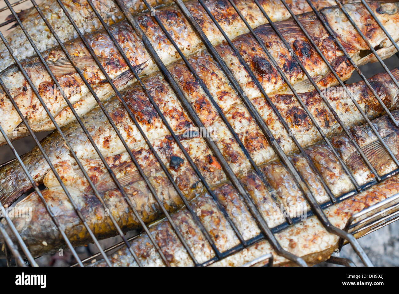 mullet cooked on the grill closeup Stock Photo - Alamy