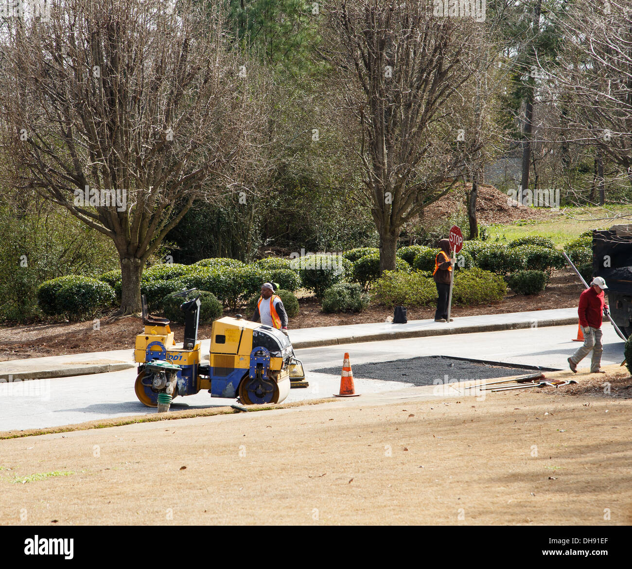 A paving crew patching streets in a residential neighborhood Stock ...