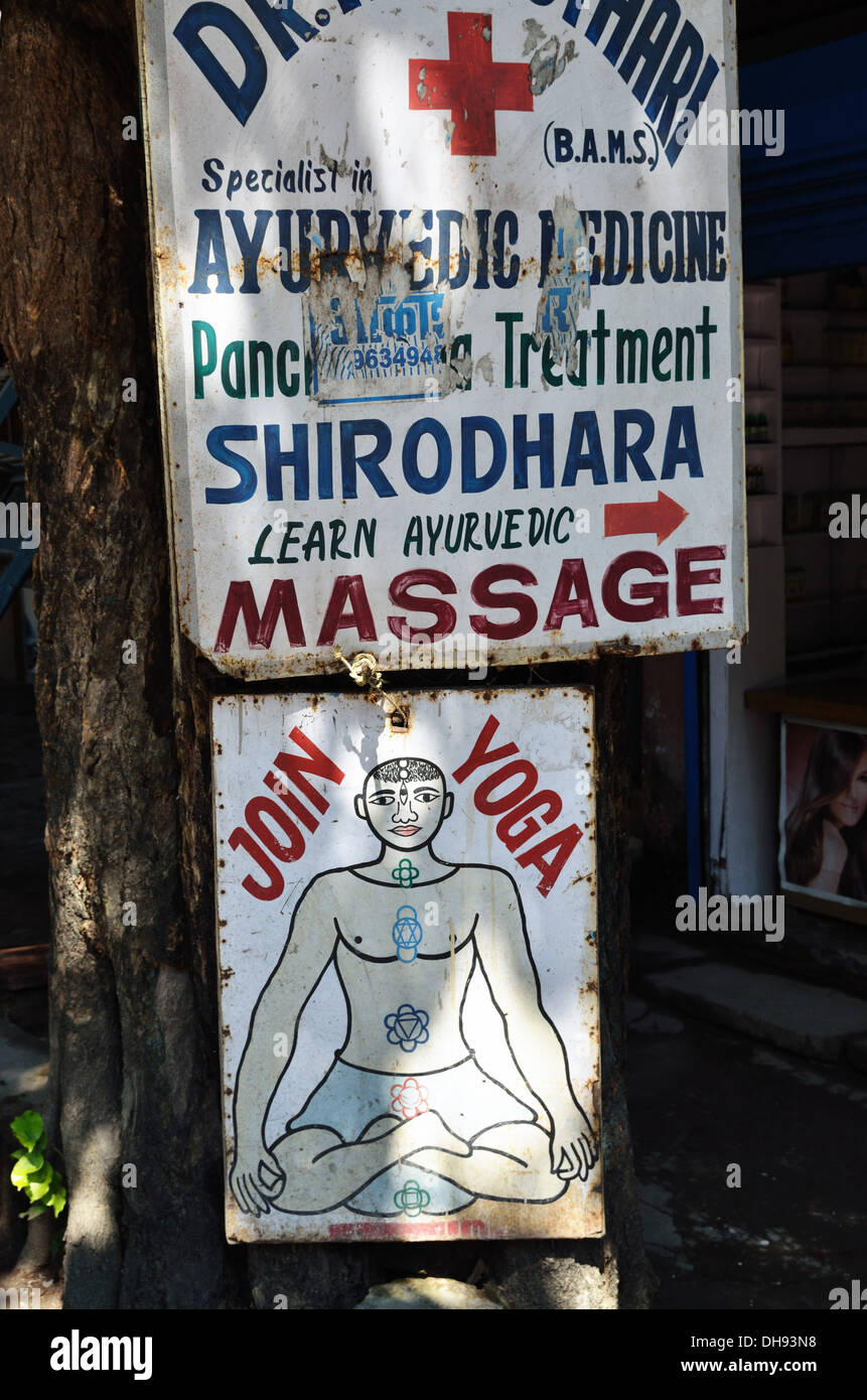 Signs on a tree, Rishikesh, India Stock Photo - Alamy