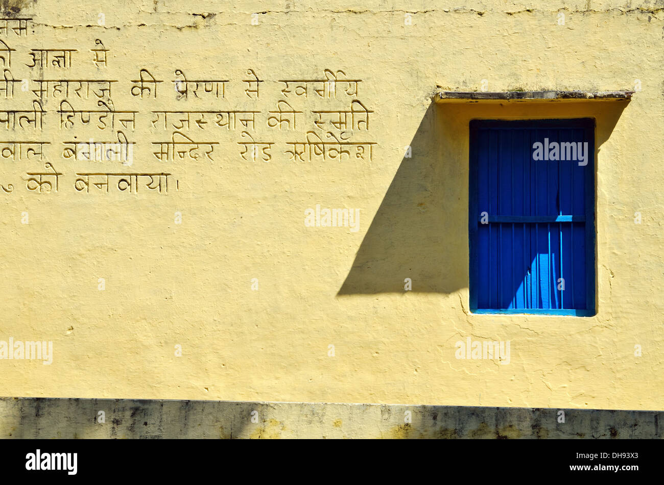 Hindi inscription on the wall with blue window, Rishikesh, India Stock ...