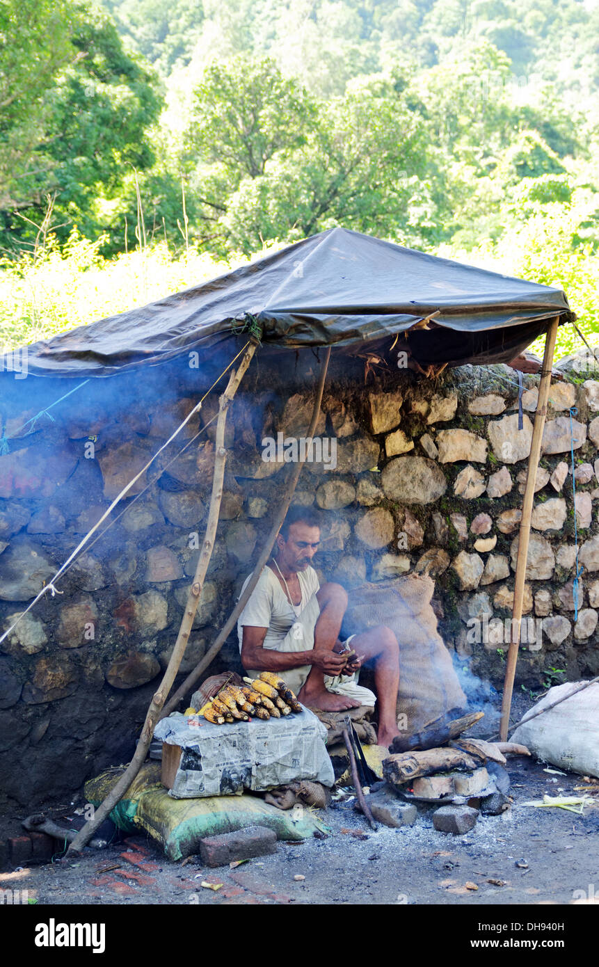 Indian man roasting corn for snacks, Rishikesh, India Stock Photo - Alamy