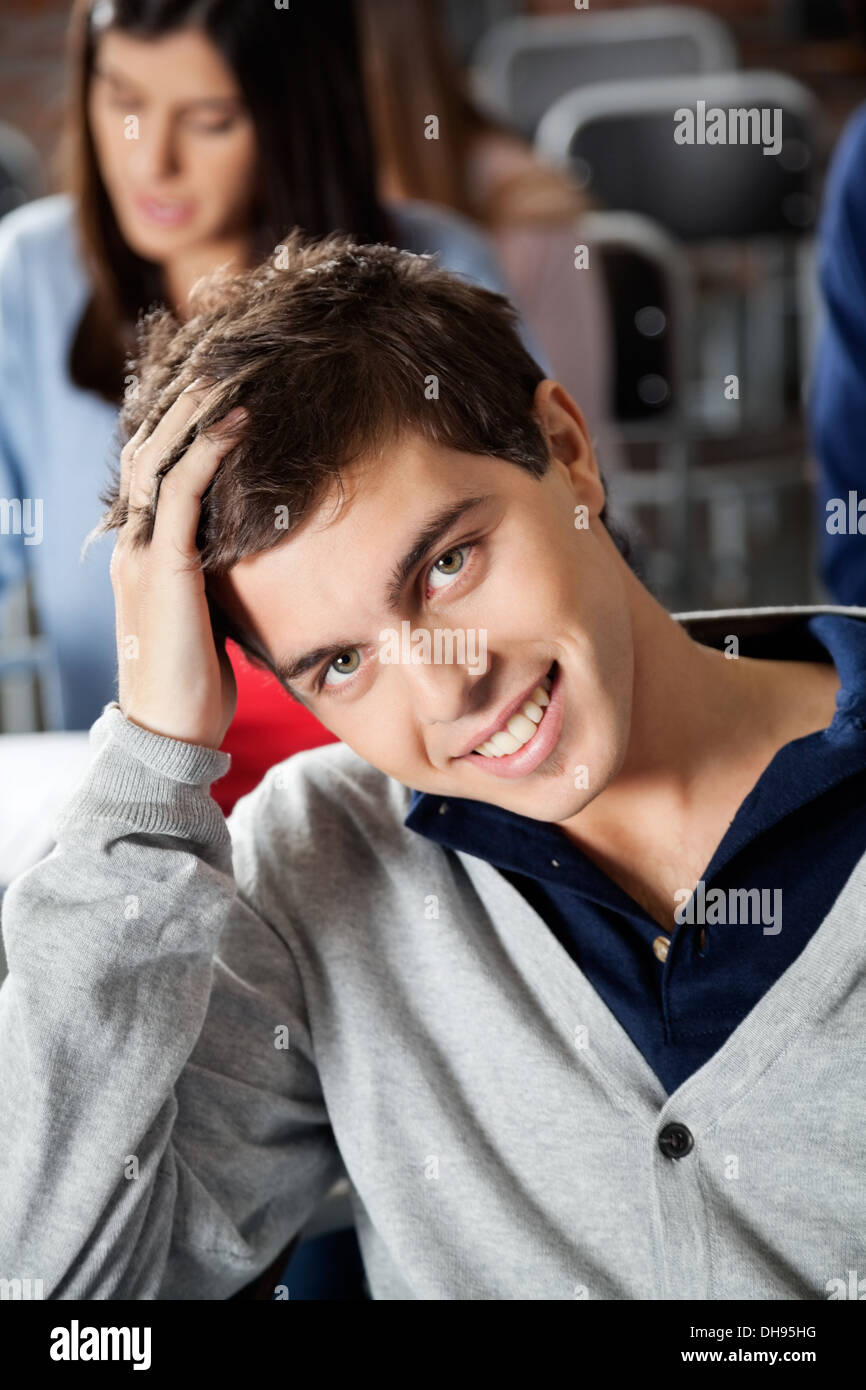 Man With Hand In Hair Smiling At Classroom Stock Photo - Alamy