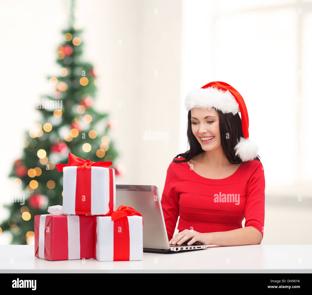 woman with gift boxes and laptop computer Stock Photo - Alamy