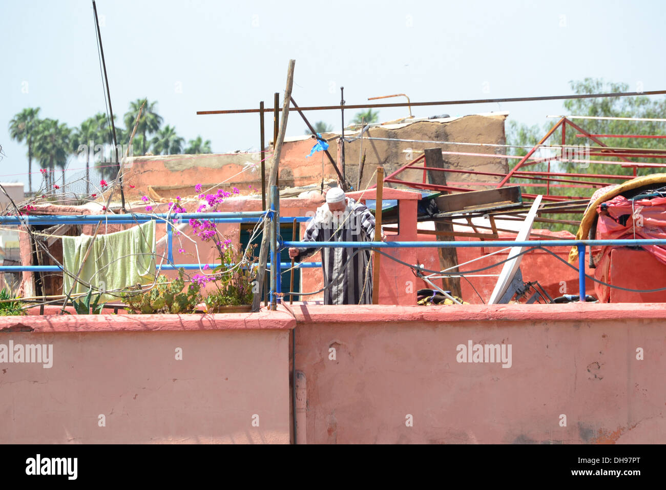 Old man looking over edge of rooftop in Marrakech Stock Photo - Alamy