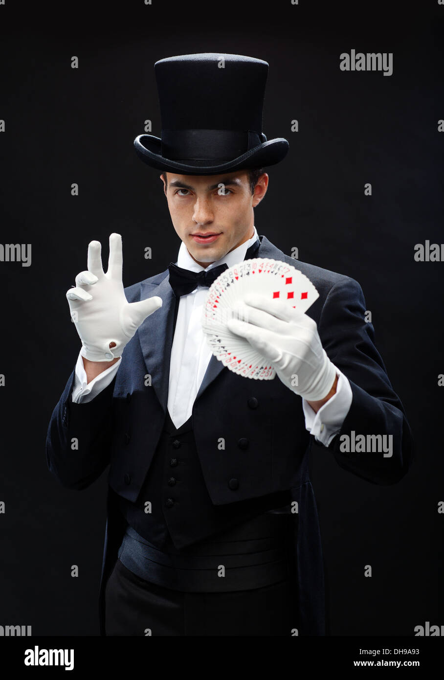 magician showing trick with playing cards Stock Photo - Alamy