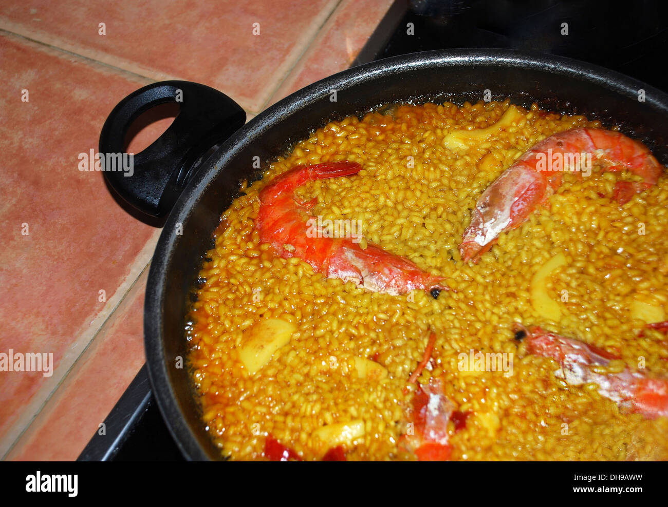 Spanish rustic rice, paella with seafood Stock Photo - Alamy