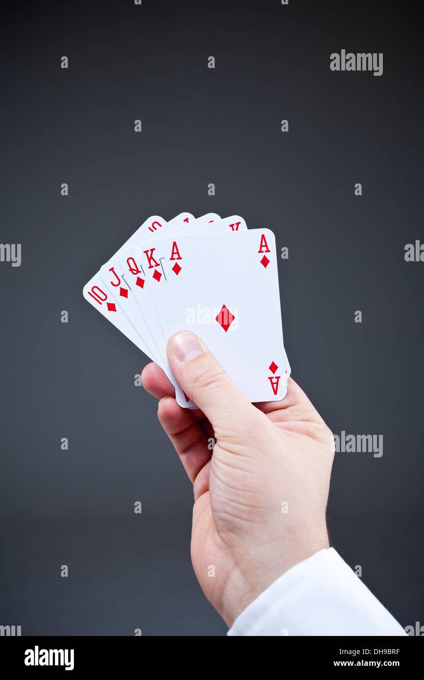 Playing cards being held in mans hand Stock Photo - Alamy