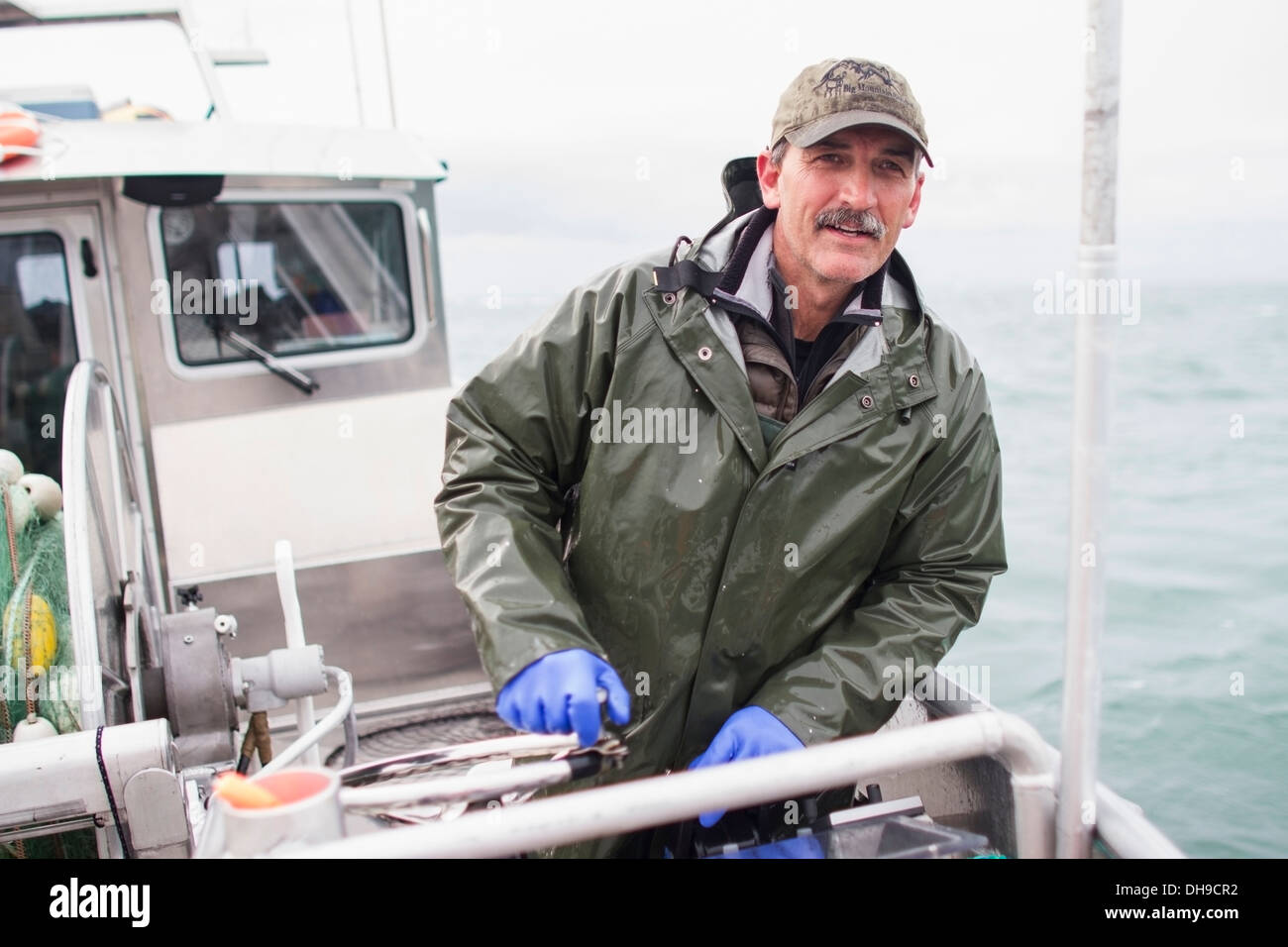 A Salmon Fisherman Driving And Scouting For Fish From The Steering ...