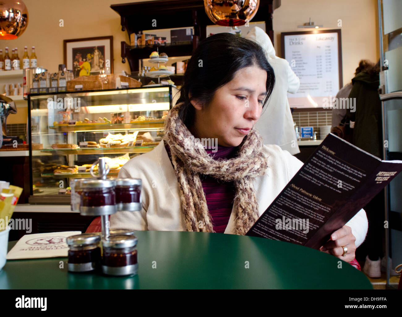 Woman looking at a menu in a cafe in Edinburgh, Scotland Stock Photo ...