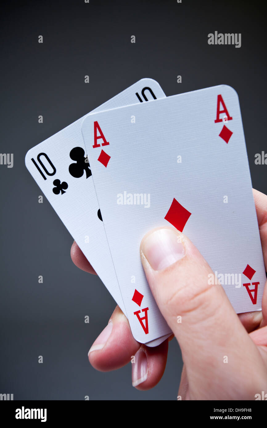 Playing cards being held in mans hand Stock Photo - Alamy