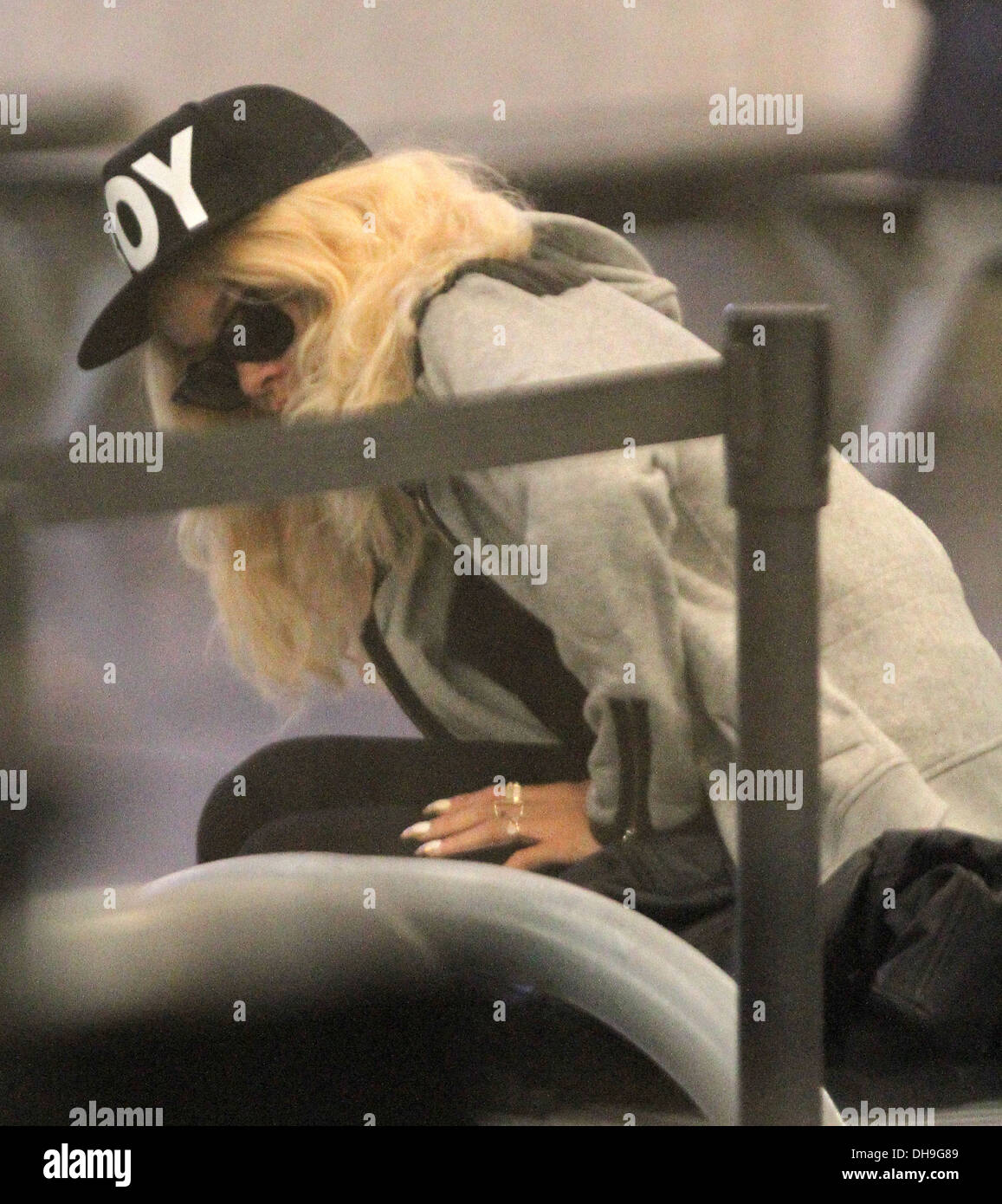 Rihanna arrives at LAX wearing a 'BOY London' cap singer was boarding a ...