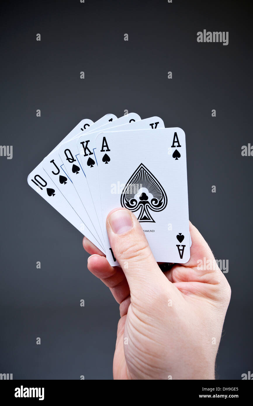 Playing cards being held in mans hand Stock Photo - Alamy