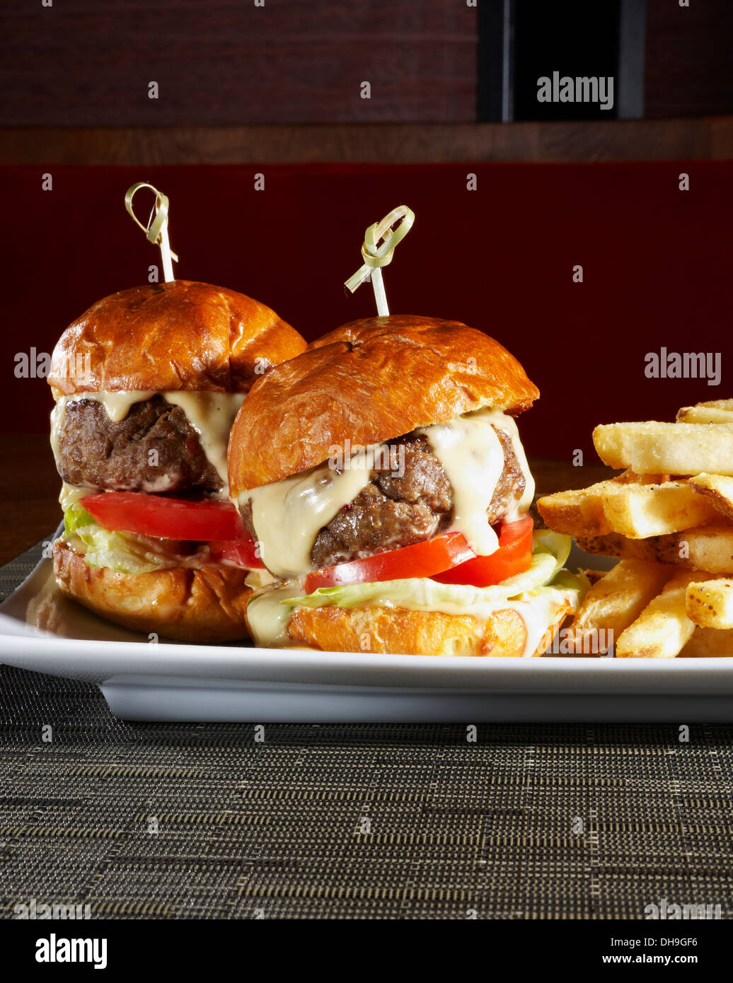 Two burger sliders on a plate with french fries Stock Photo - Alamy