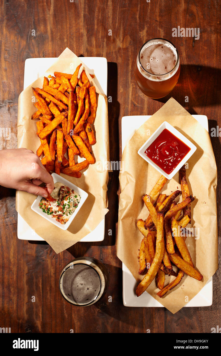 chips on platter look down, one chip being dipped into sauce Stock ...