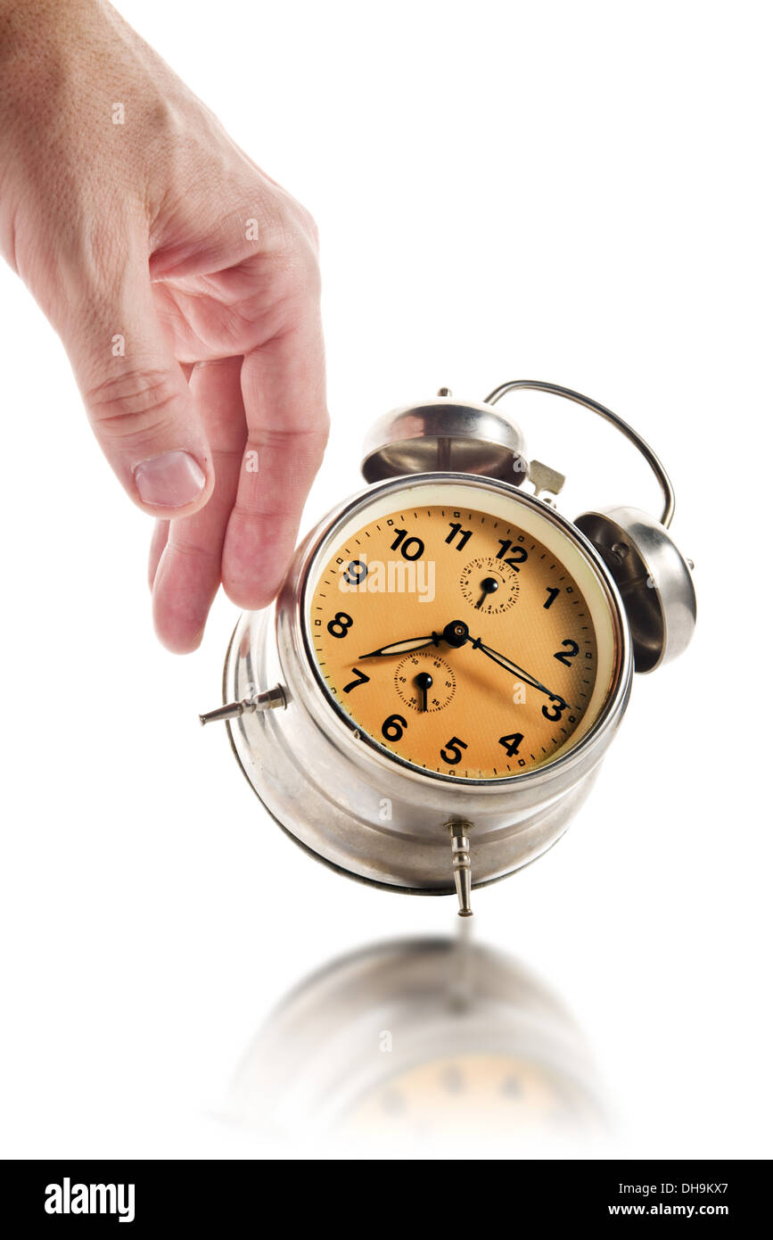 Hand knocking down vintage clock showing quarter past seven over a ...