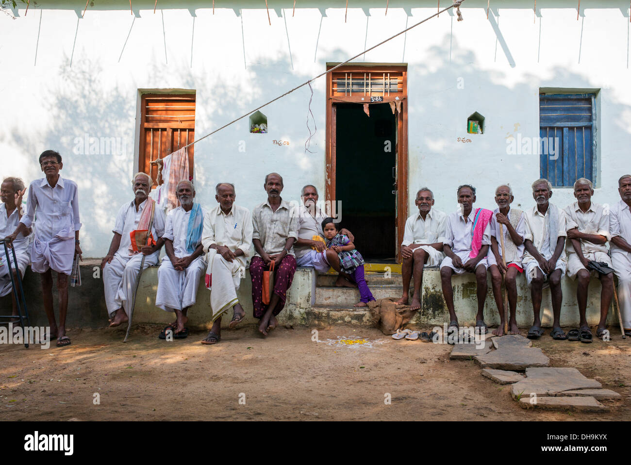 Rural Indian elderly men patients sat queuing at the Sri Sathya Sai ...