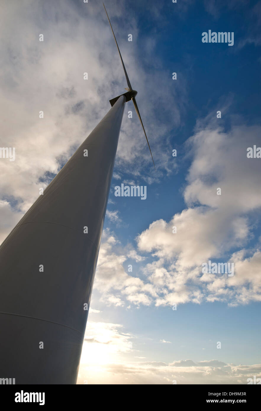 Windmill spinning towards a dark blue sky and an rising sun Stock Photo ...