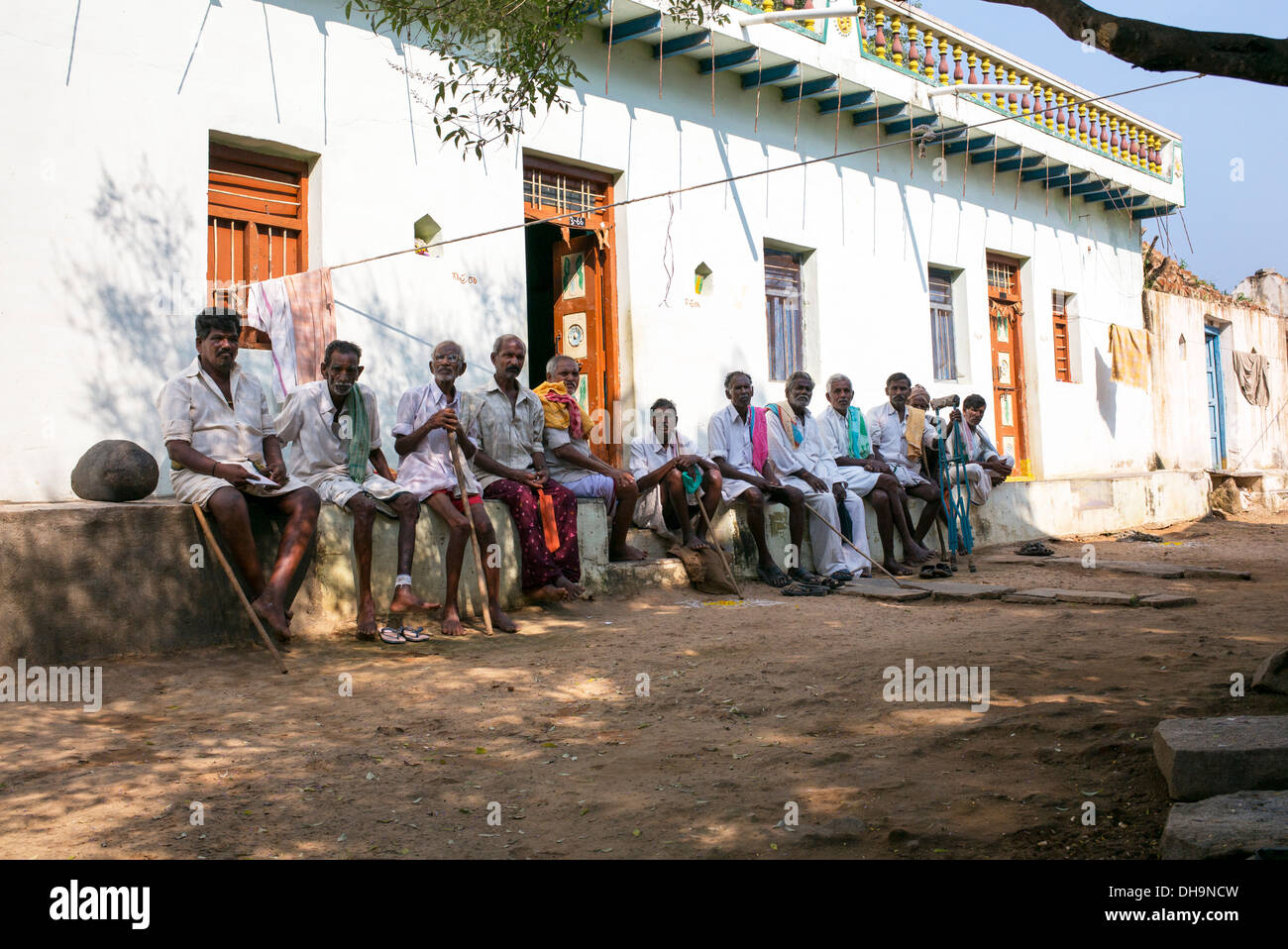 Rural Indian elderly men patients sat queuing at the Sri Sathya Sai ...