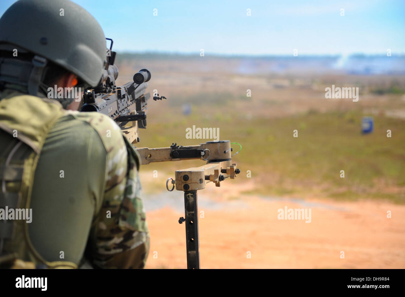 An Army Special Forces member fires upon targets with the M240B machine ...