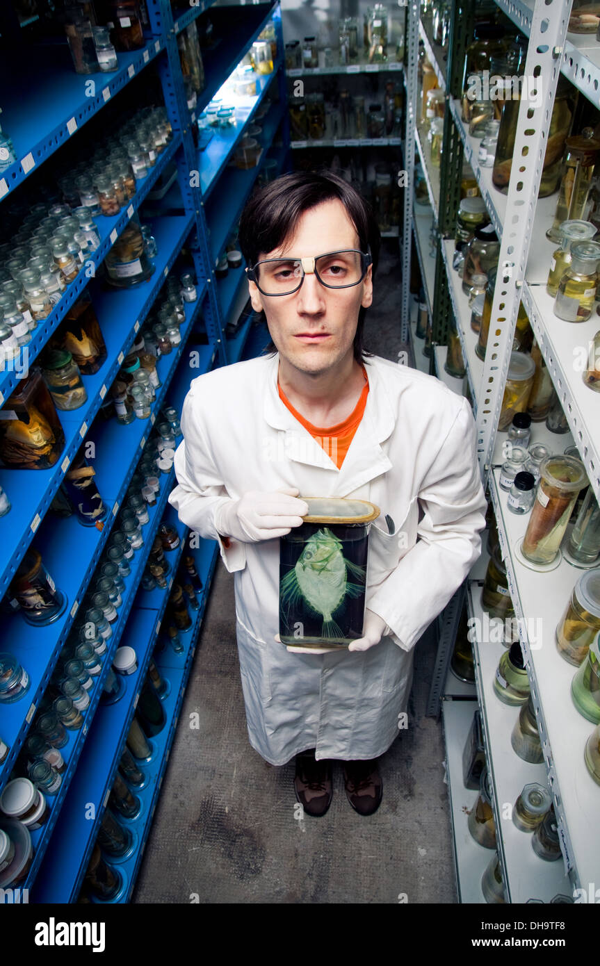 Strange scientist holding fish in formalin Stock Photo - Alamy