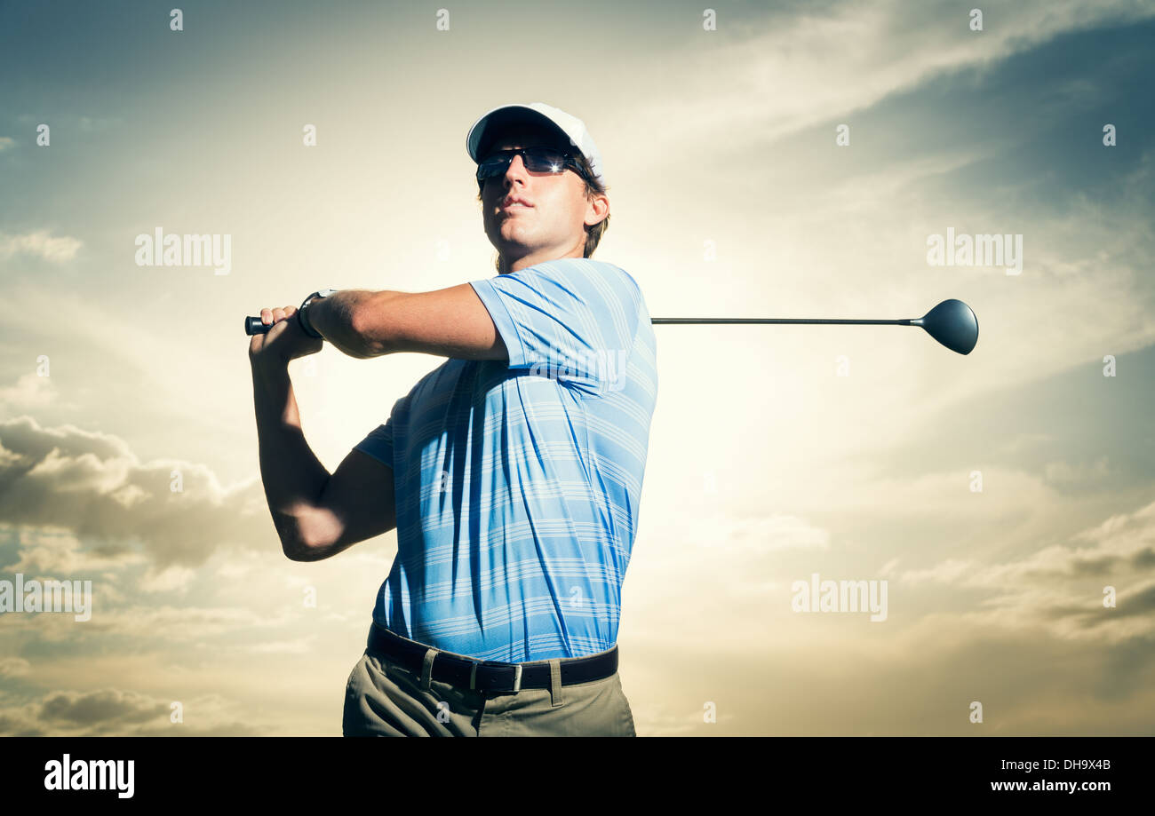 Golfer at sunset, Man swinging golf club with dramatic sunset sky Stock ...
