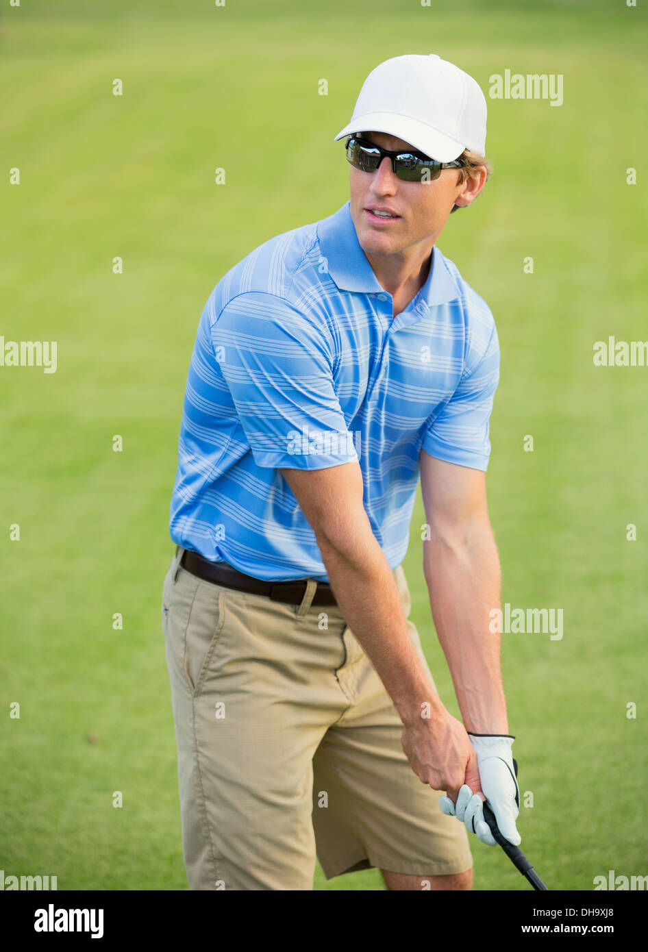 Athletic young man playing golf, Portrait of Golfer on Course Stock ...