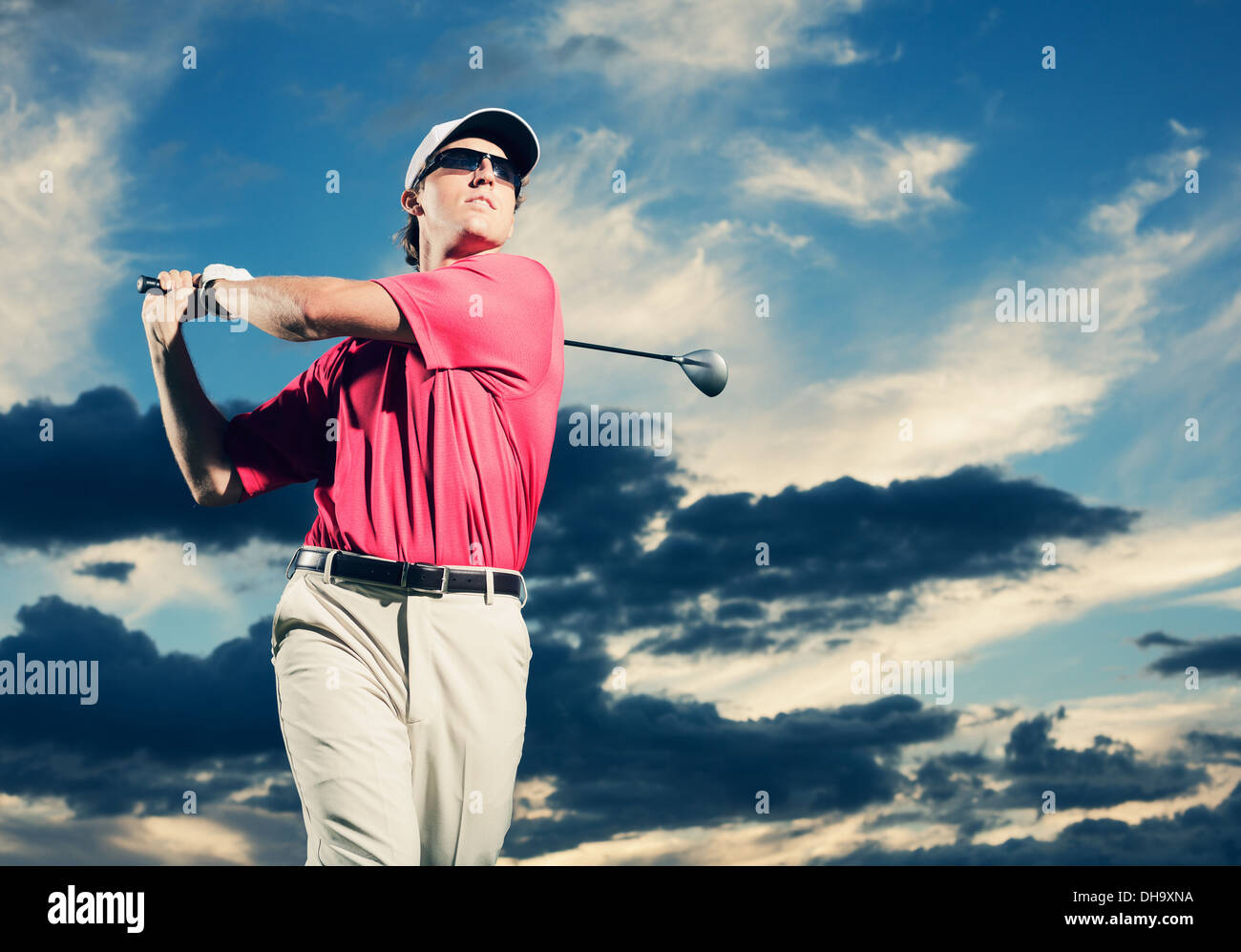 Golfer at sunset, Man swinging golf club with dramatic sunset sky ...