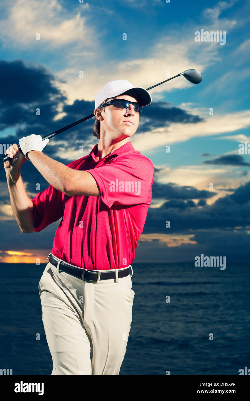 Golfer at sunset, Man swinging golf club with dramatic sunset sky ...