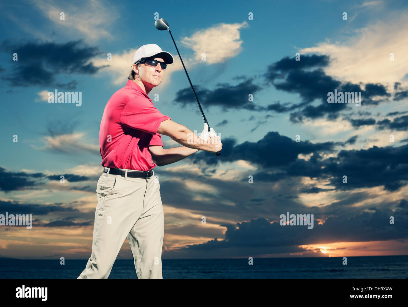 Golfer at sunset, Man swinging golf club with dramatic sunset sky ...