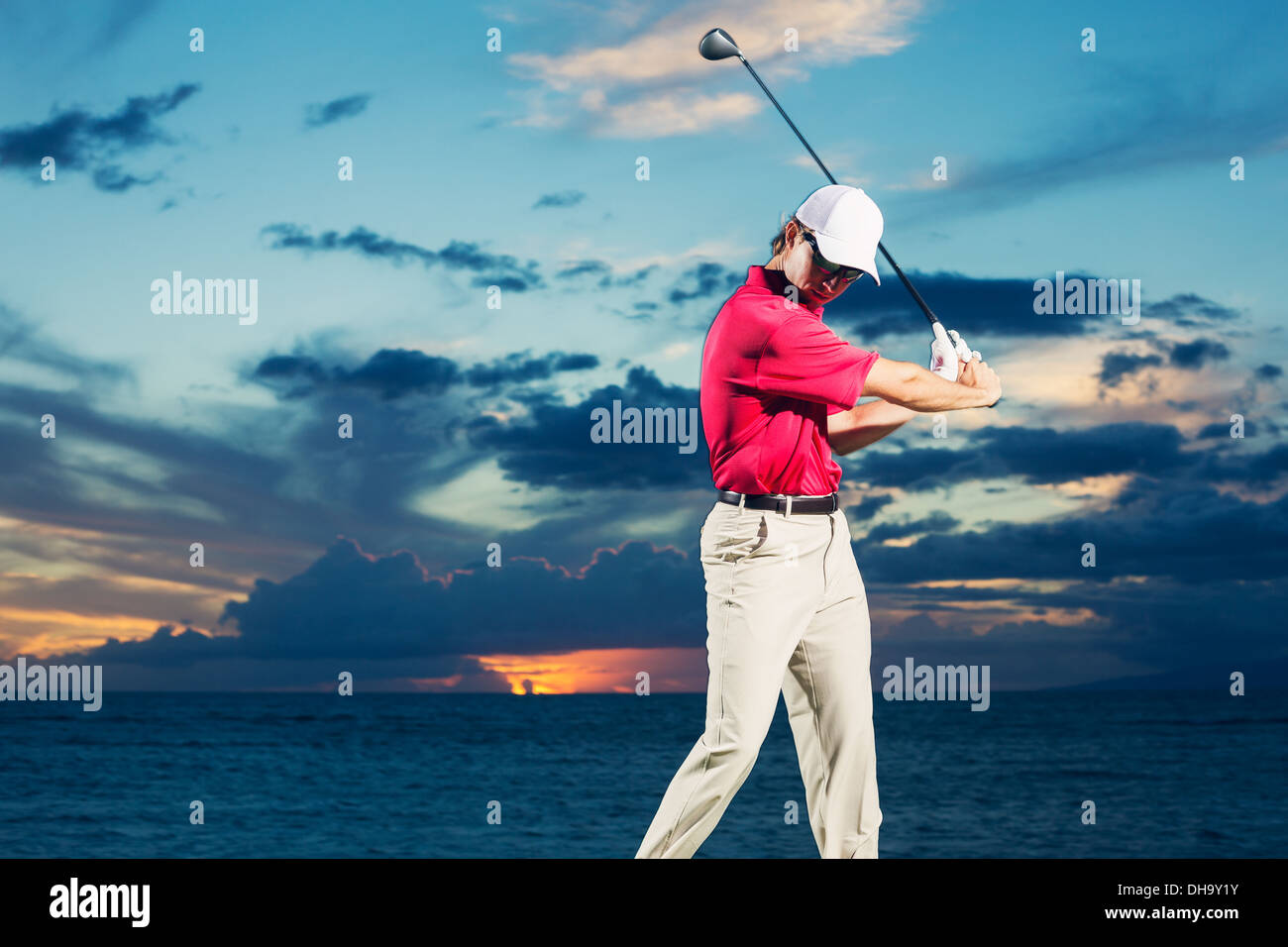 Golfer at sunset, Man swinging golf club with dramatic sunset sky ...