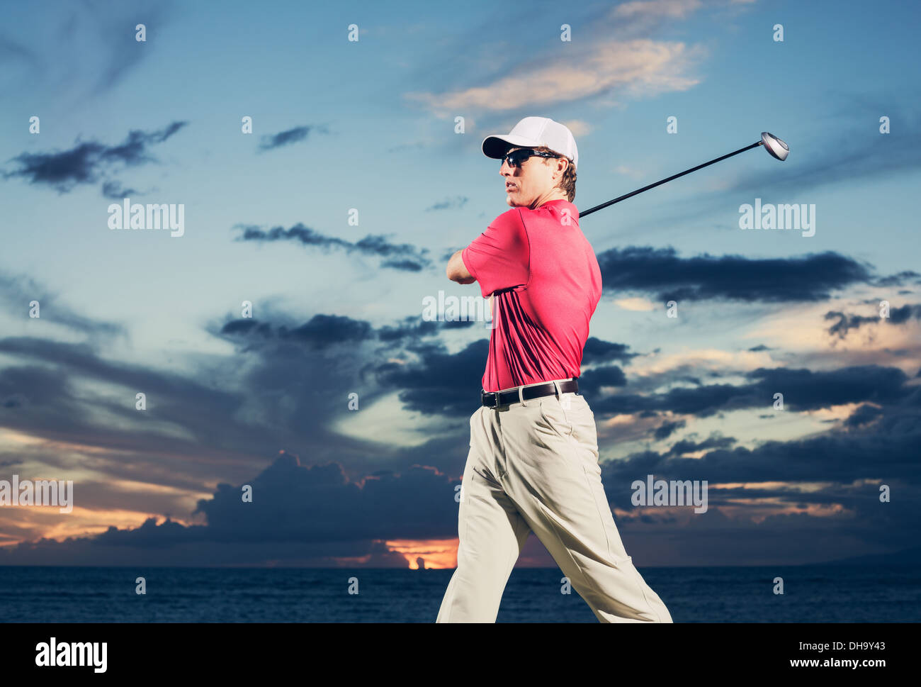 Golfer at sunset, Man swinging golf club with dramatic sunset sky ...