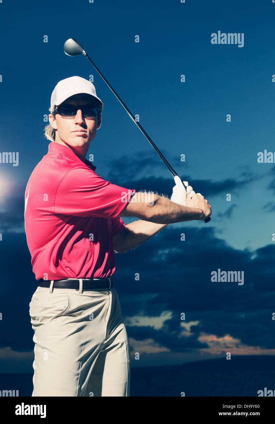 Golfer at sunset, Man swinging golf club with dramatic sunset sky ...