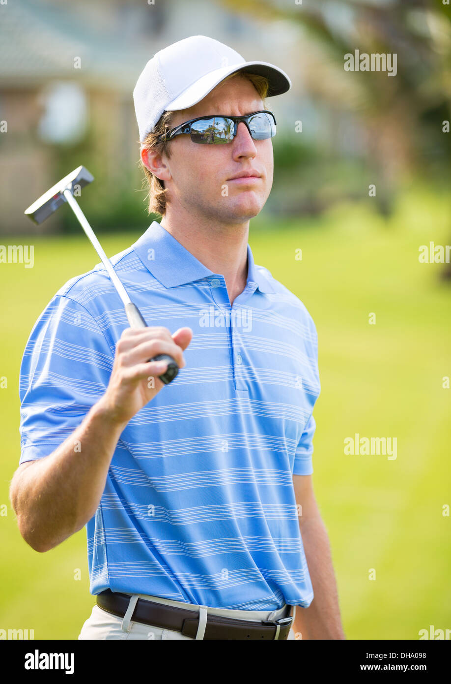 Athletic young man playing golf, Portrait of Golfer on Course with ...